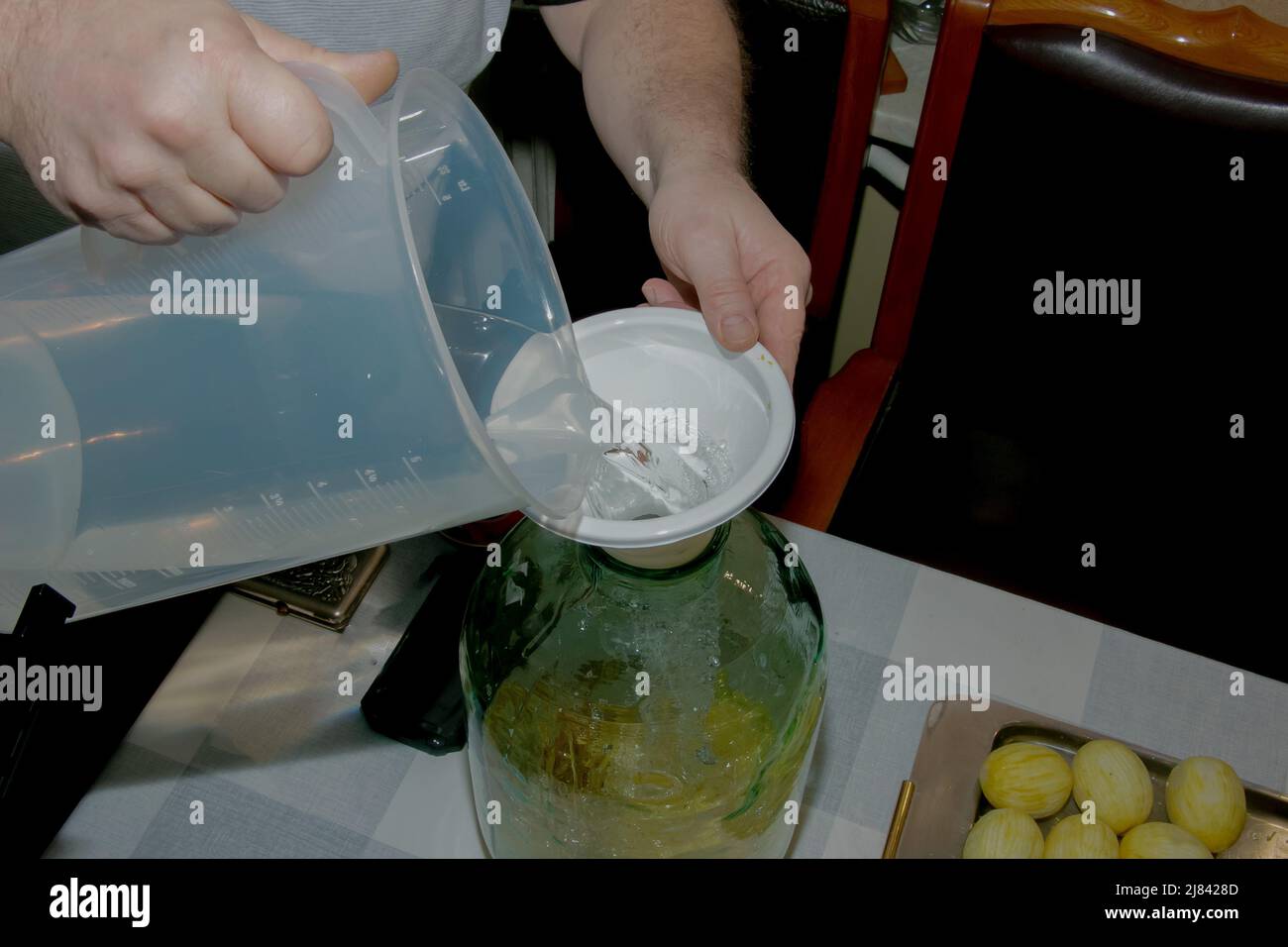 The process of preparing an alcoholic drink Limoncello at home. Men's ...