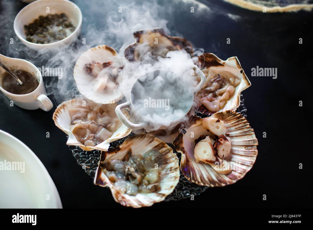 Seafood on plates in the form of shells Stock Photo - Alamy