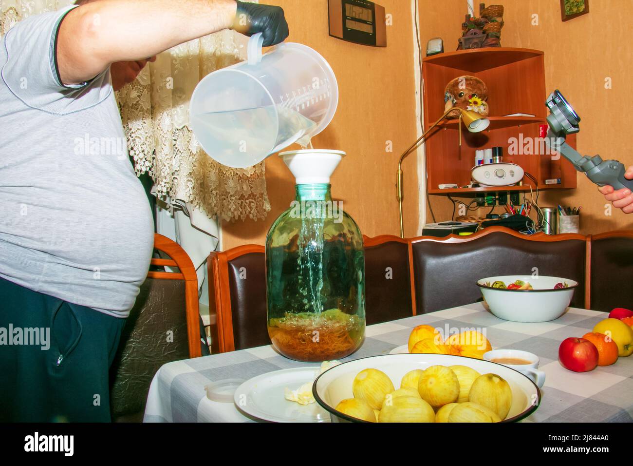 The process of preparing an alcoholic drink orancello at home. A man ...
