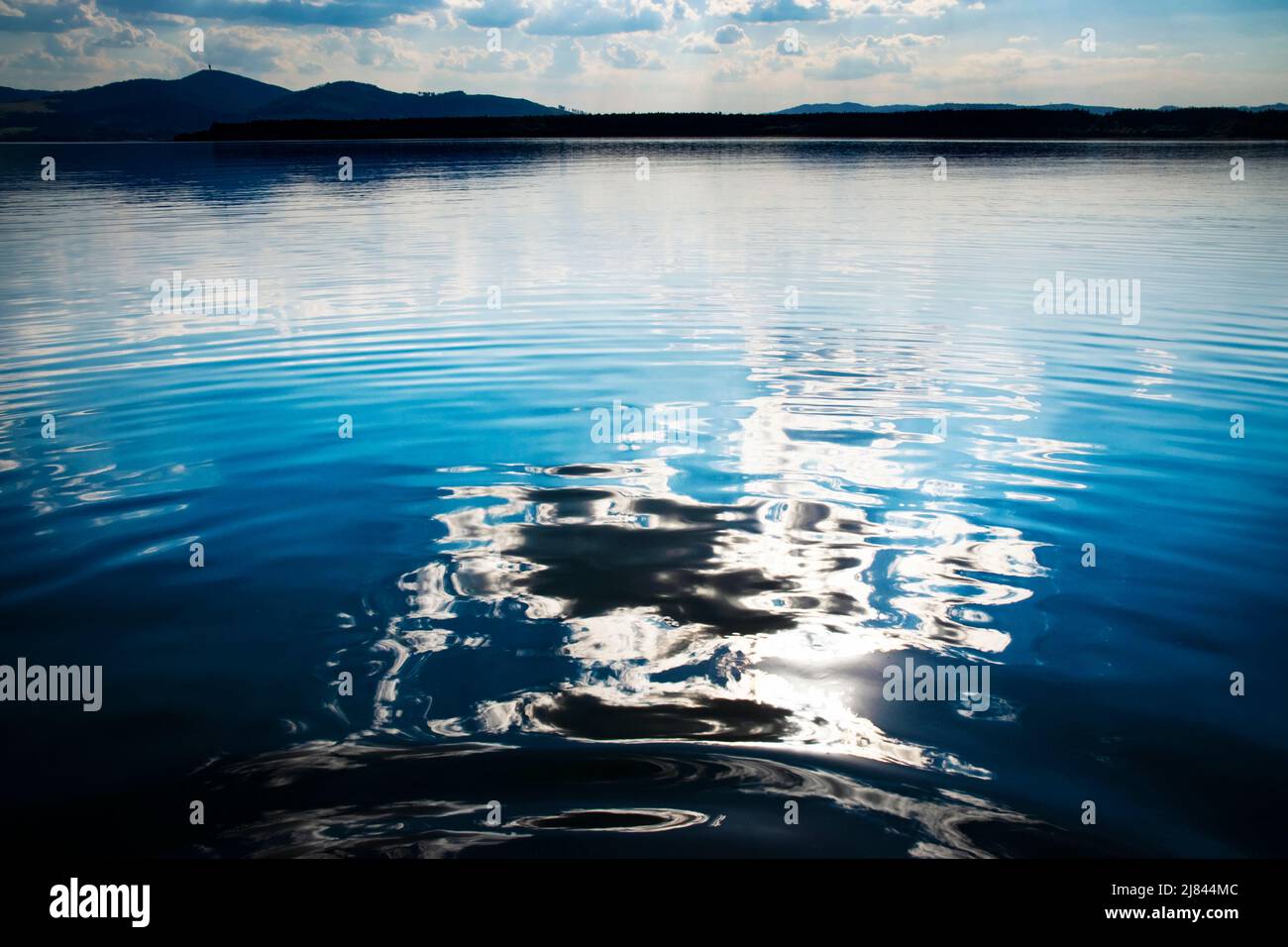 nature background abstract reflection of a cloud on a lake water ...