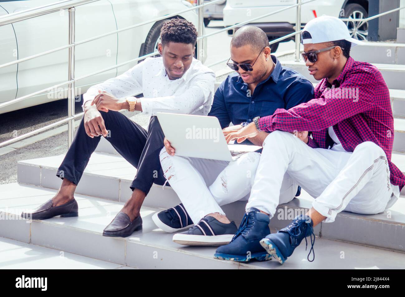 friends studying and networking, sitting together working laptop on ...