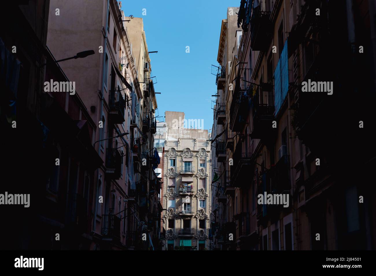 little alley in the street of barcelona with historic building in the ...