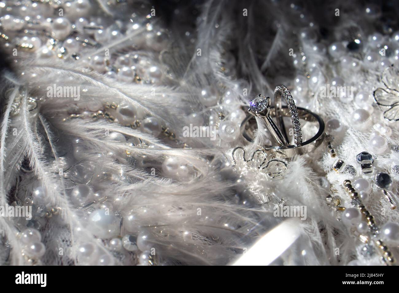 Wedding rings with a diamond on wedding dress background Stock Photo ...