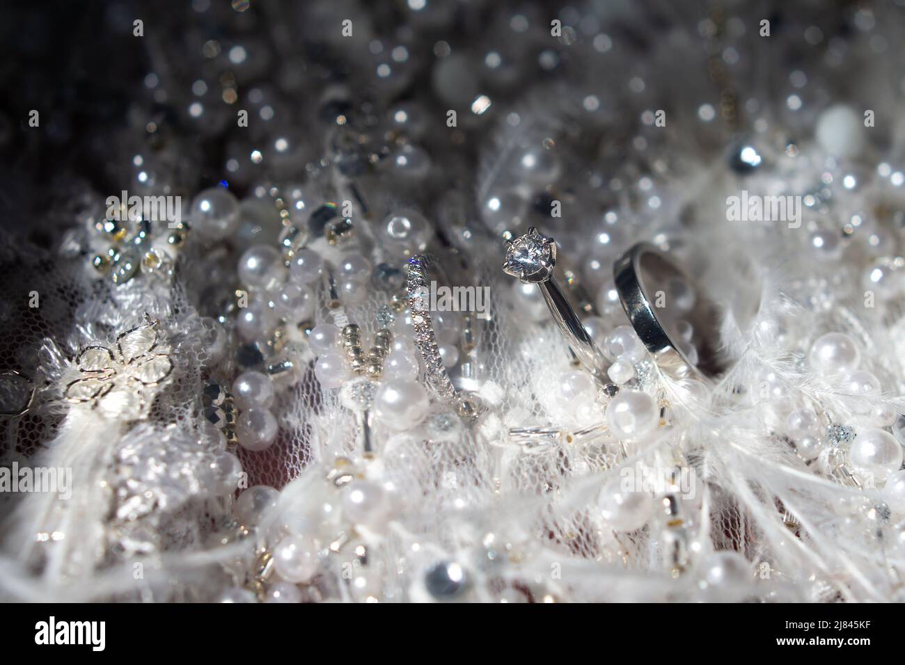 Wedding rings with a diamond on wedding dress background Stock Photo ...