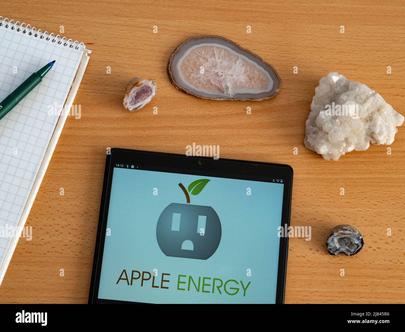 In this photo illustration Apple Energy LLC owned by Apple Inc. logo ...