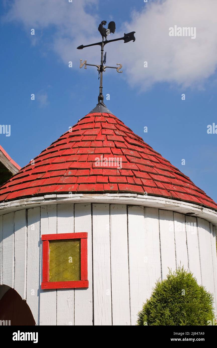 White wood plank tower with red cedar shingles roof and rooster shape ...