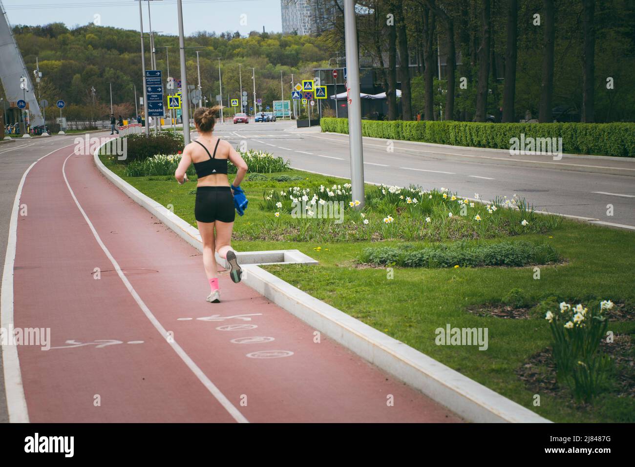 MOSCOW, RUSSIA - MAY 11, 2022: A woman trains running on the treadmills ...