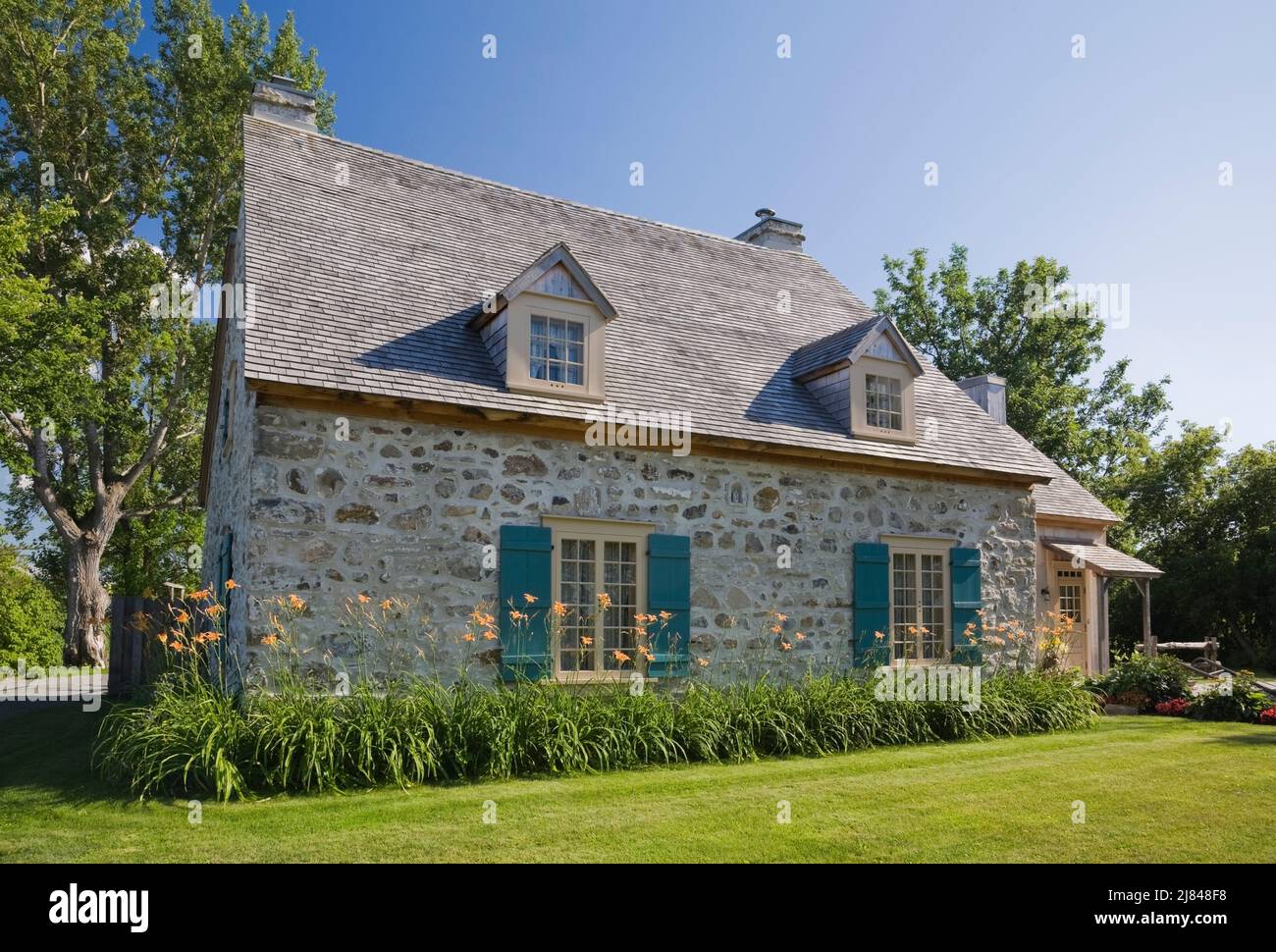 Old 1722 Canadiana cottage style fieldstone home with blue trim and ...