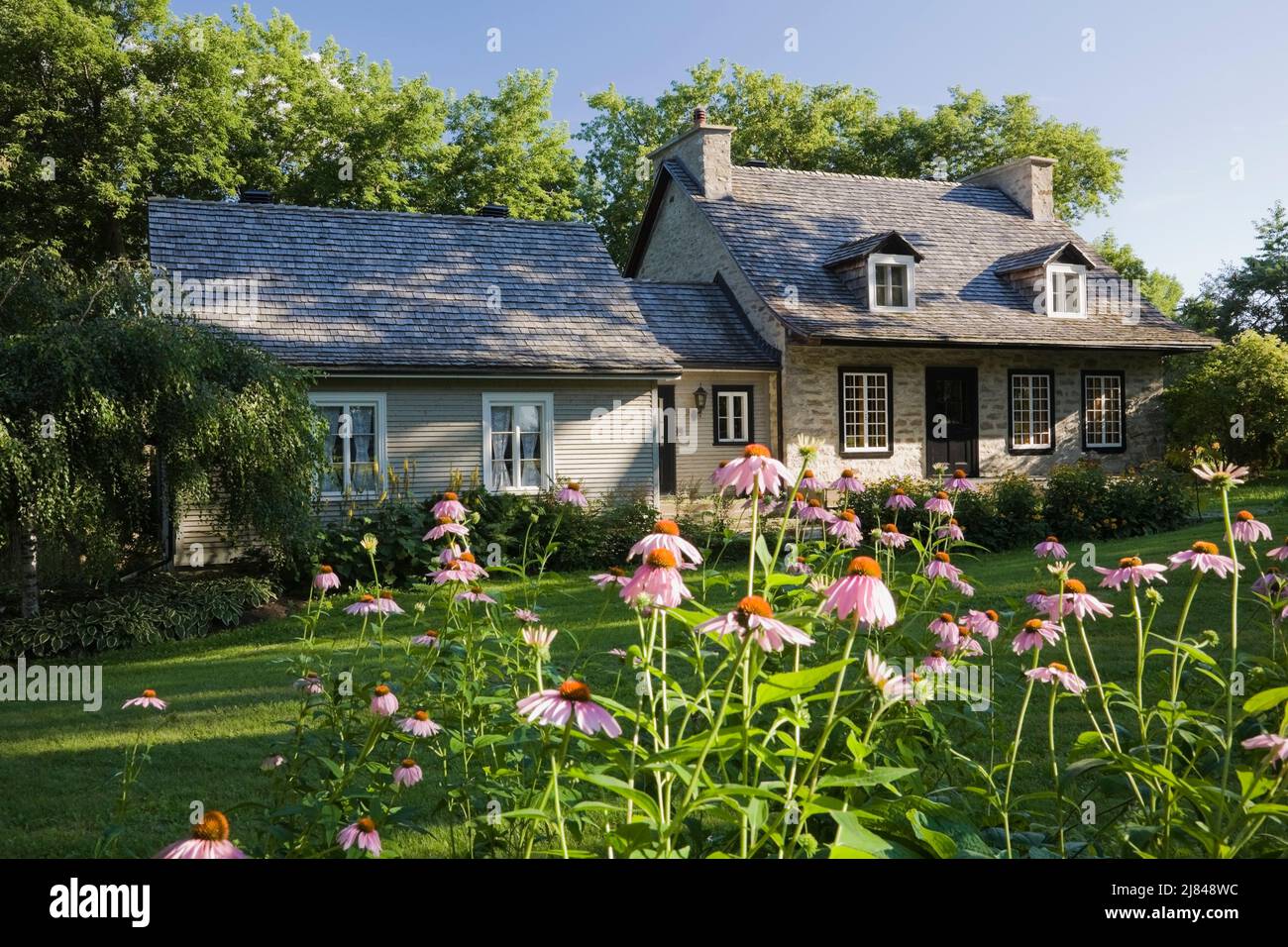 Old 1825 Canadiana cottage style fieldstone home facade with cedar wood ...