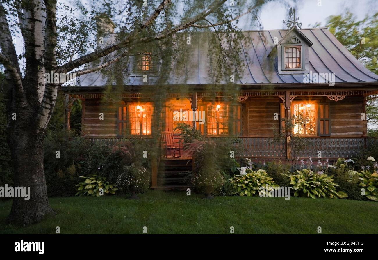 Old reconstructed 1800s Canadiana cottage style log home with brownish ...