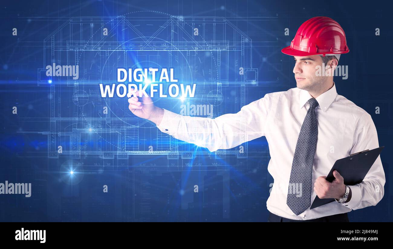 Handsome architect drawing with helmet Stock Photo - Alamy