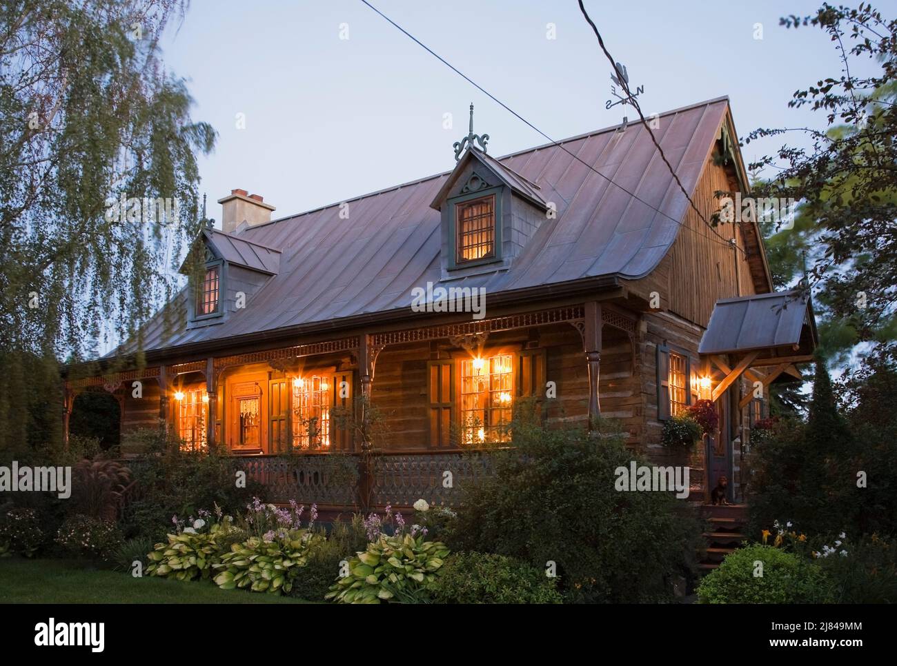 Old reconstructed 1800s Canadiana cottage style log home with brownish ...