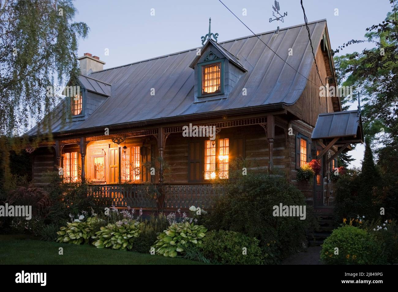 Old reconstructed 1800s Canadiana cottage style log home with brownish ...