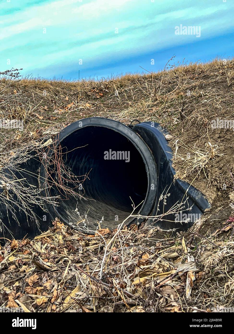 HDPE drainage culvert under a road entrance. Pipe is used to convey ...