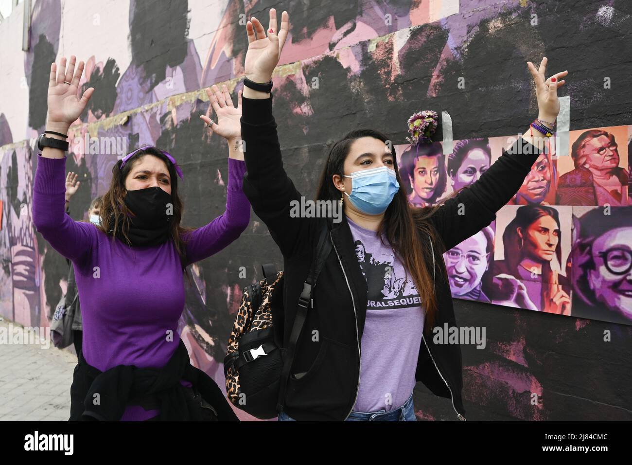 People gather to stage a protest after a feminist mural, depicting ...