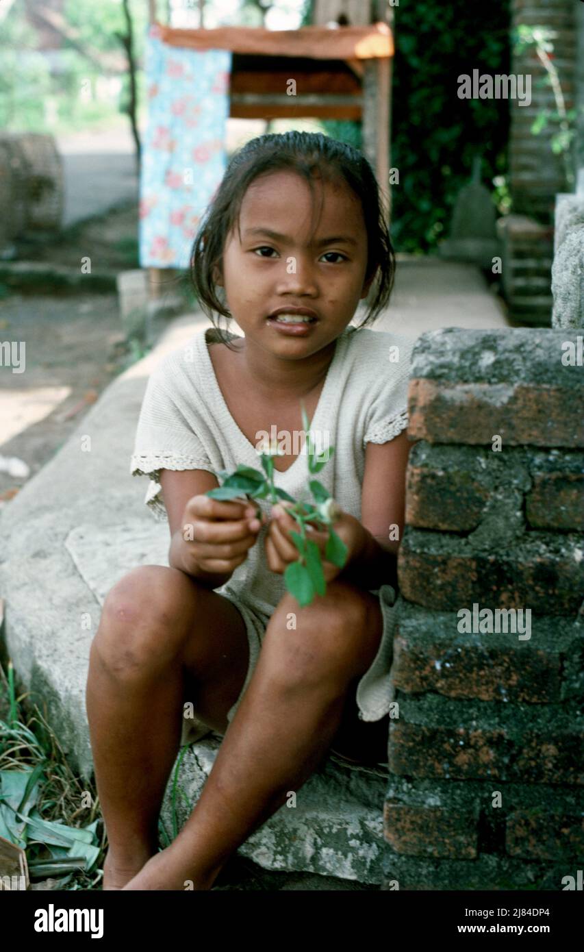 Girl holding a flower in Ubud, Bali 1984 Stock Photo - Alamy