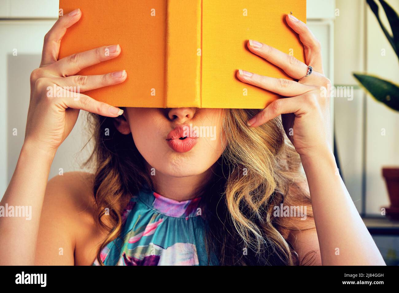 young college woman covering eyes with yellow book library school Stock ...