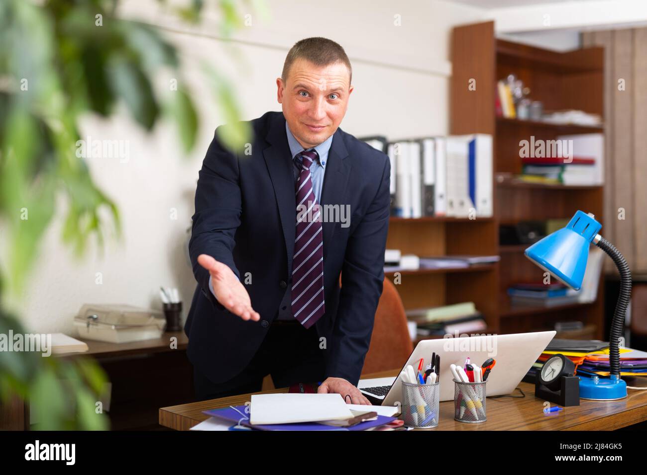 Portrait of man welcoming to company office Stock Photo - Alamy