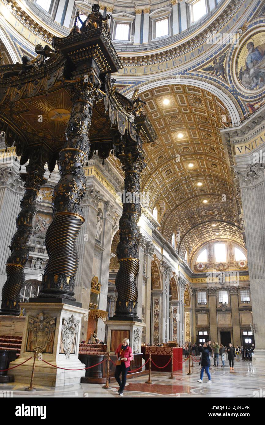 Tourists admiring Bernini's baldacchino in Saint Peter's Basilica ...