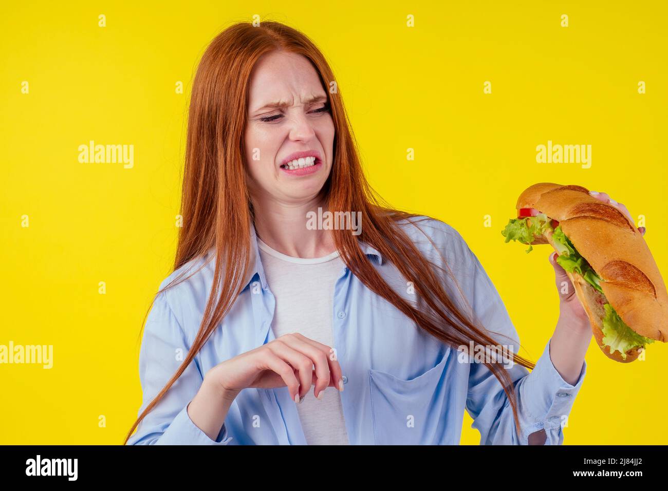 disgust distaste aversion redhaired ginger woman holding huge sandwich ...
