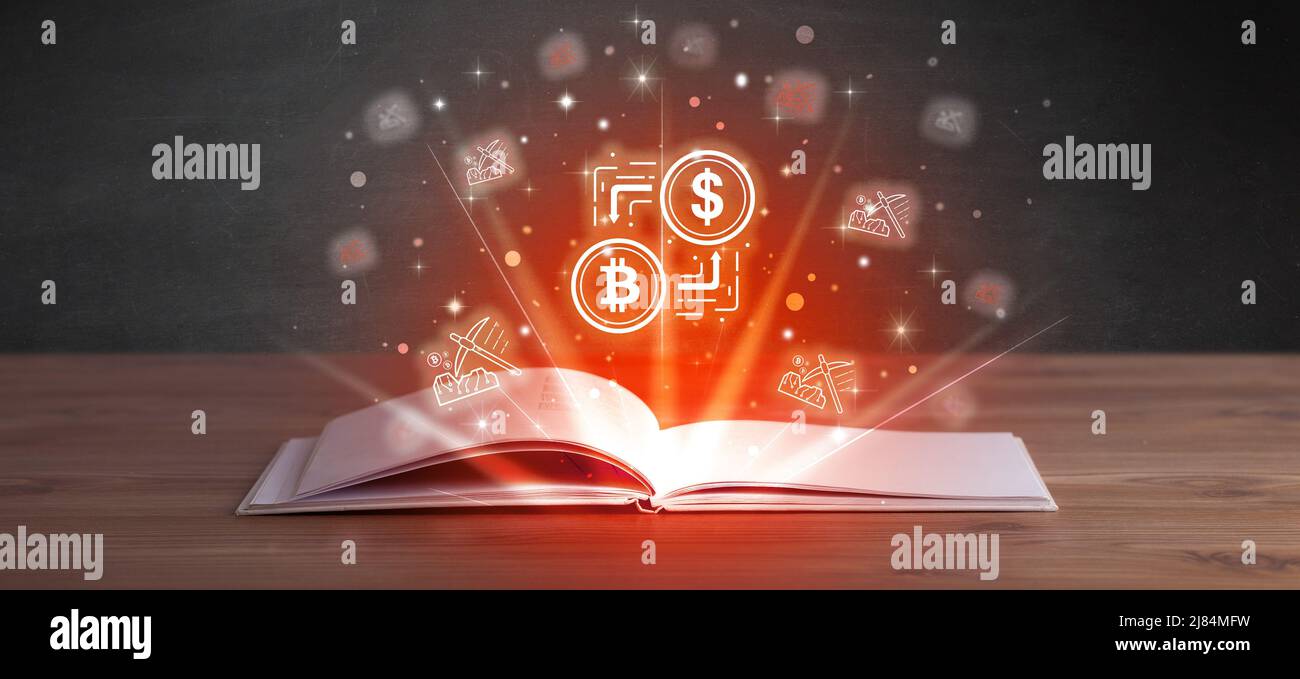 Open book with currency icons above Stock Photo - Alamy