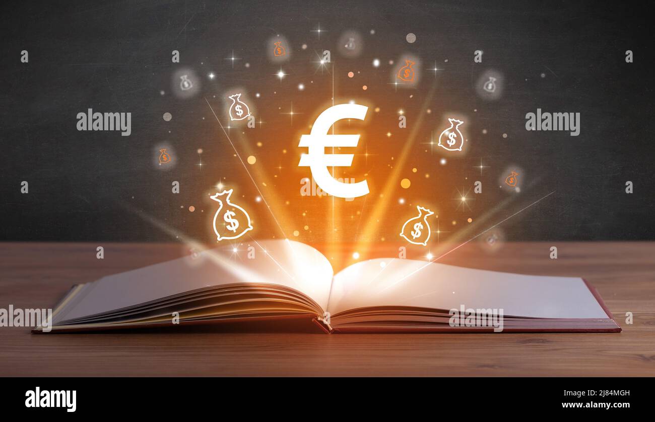 Open book with currency icons above Stock Photo - Alamy