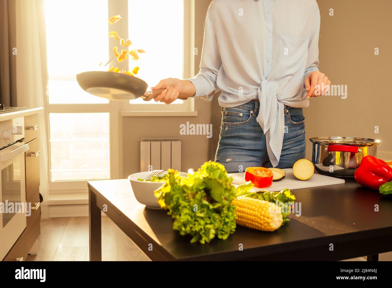 happy redhaired ginger woman cooking in evening sun lights sunset ...