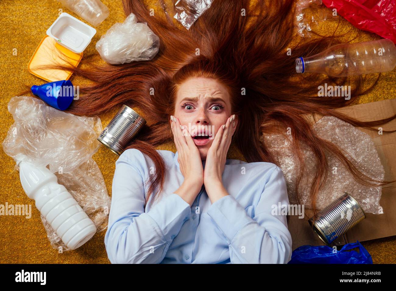 unhappy redhaired ginger girl sorting waste:bottle,paper and plastic ...