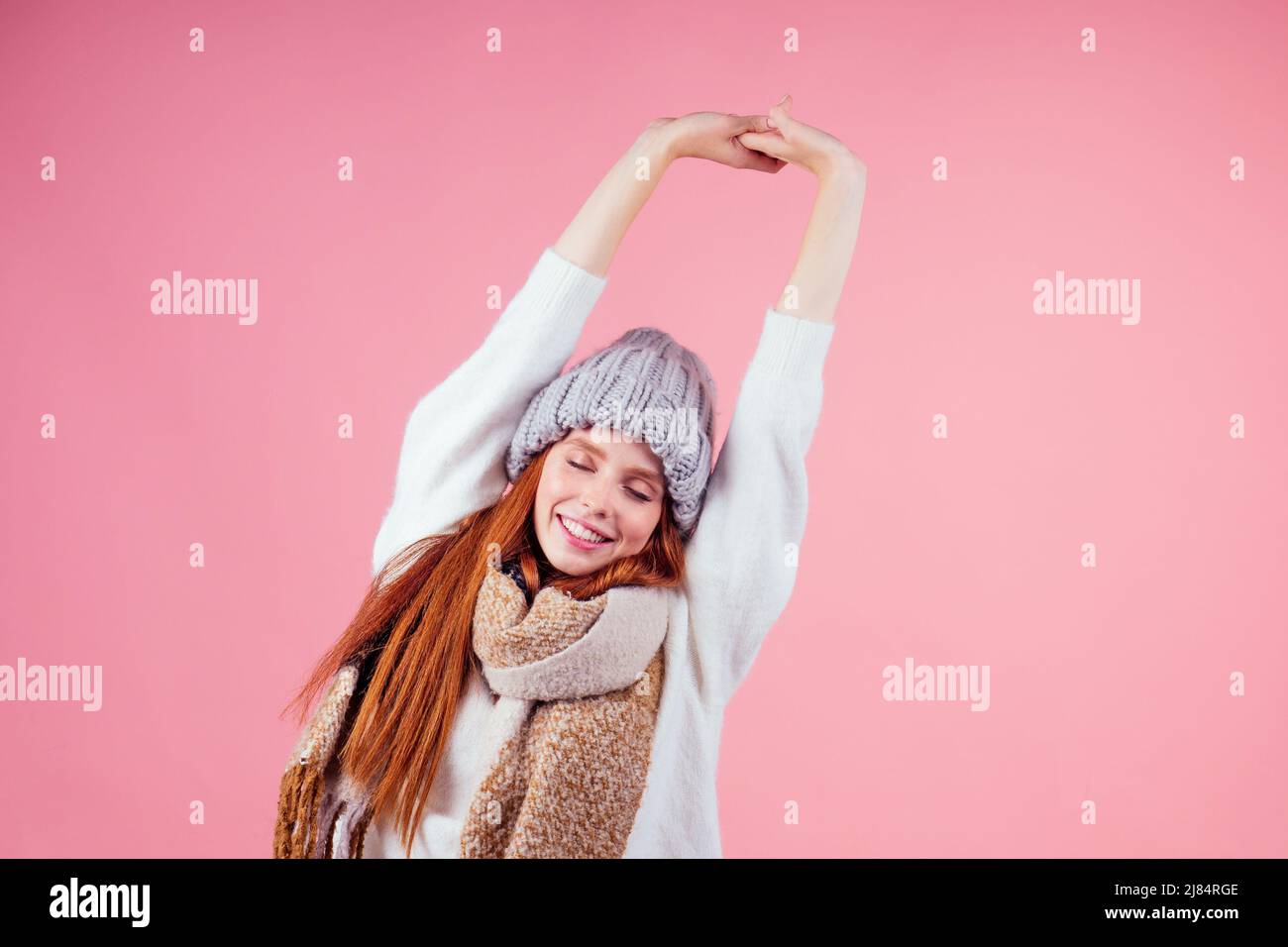 redhaired ginger woman yawning and stretching the body after winter ...