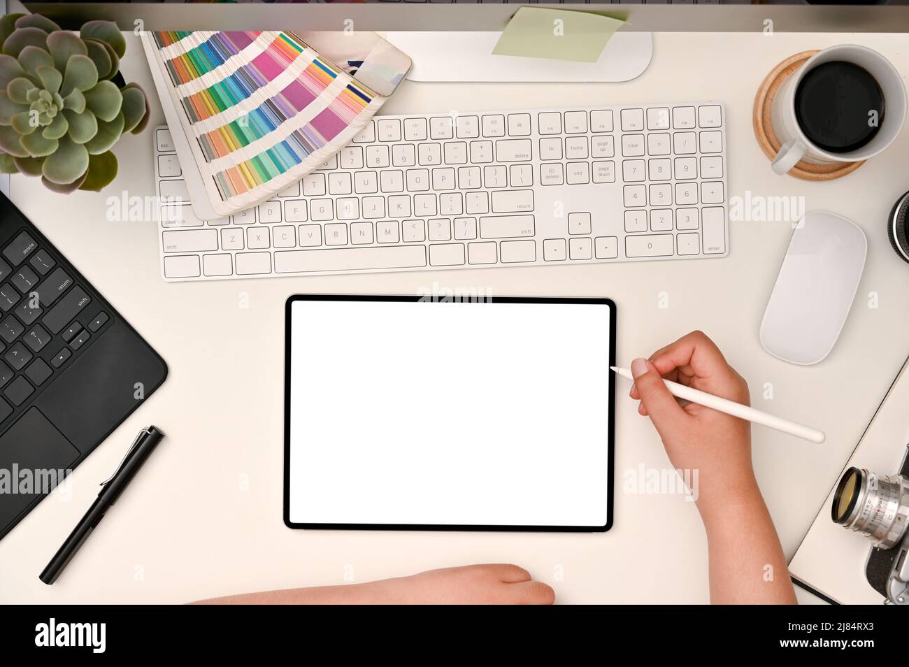 Modern graphic designer workspace top view, flat lay, with a female using stylus pen drawing on ...