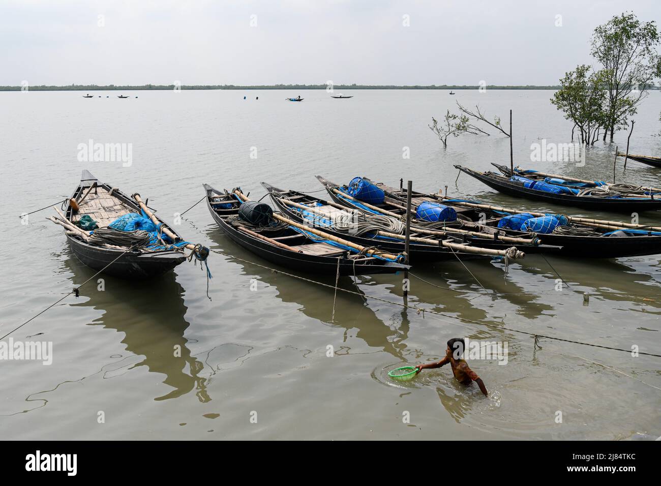May 6, 2022, Satkhira, Bangladesh: A child catches small fish with a ...