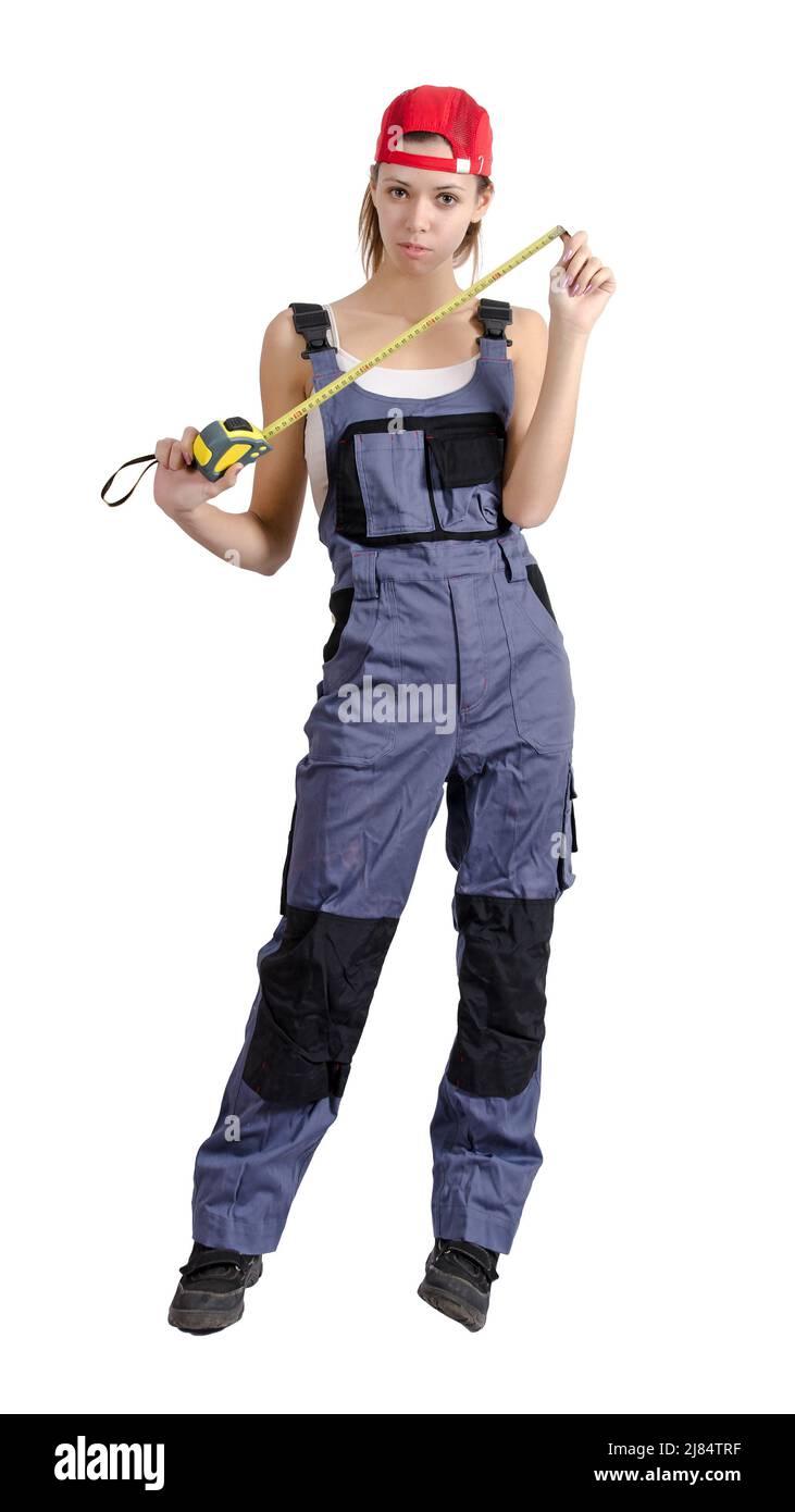 Young girl in overalls with a construction tape measure in hand ...