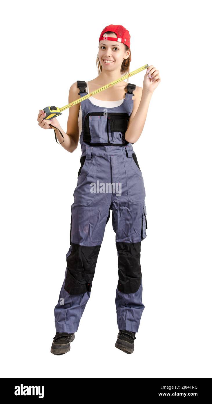 Young girl in overalls with a construction tape measure in hand ...