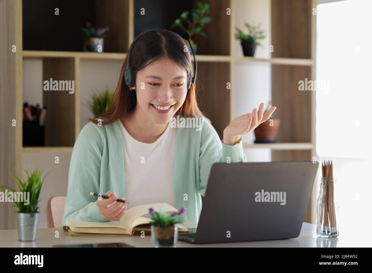 Young college student have question and answer to teacher by video call ...