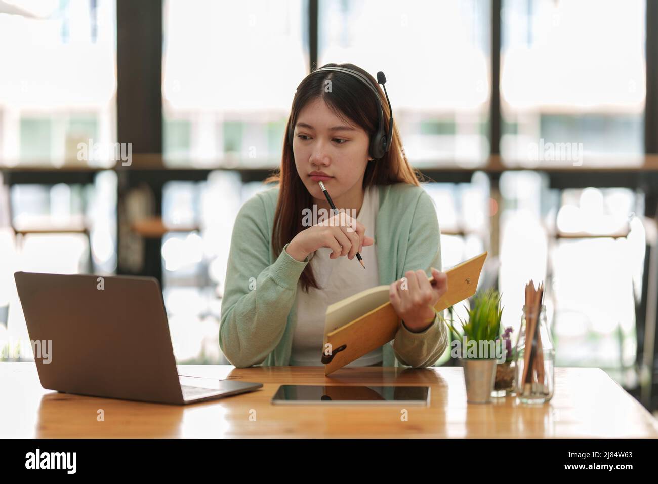 Young college student have question and answer to teacher by video call ...