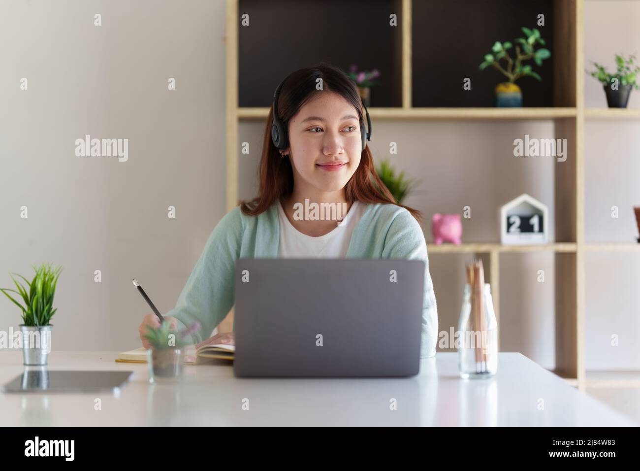 Young college student have question and answer to teacher by video call ...