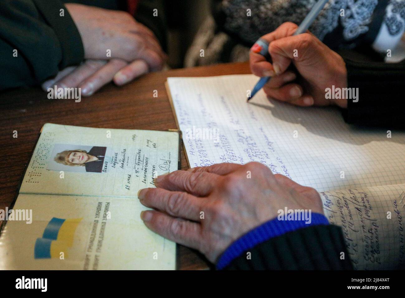 Kharkiv, Ukraine. 12th May, 2022. A local resident presents her ID card ...