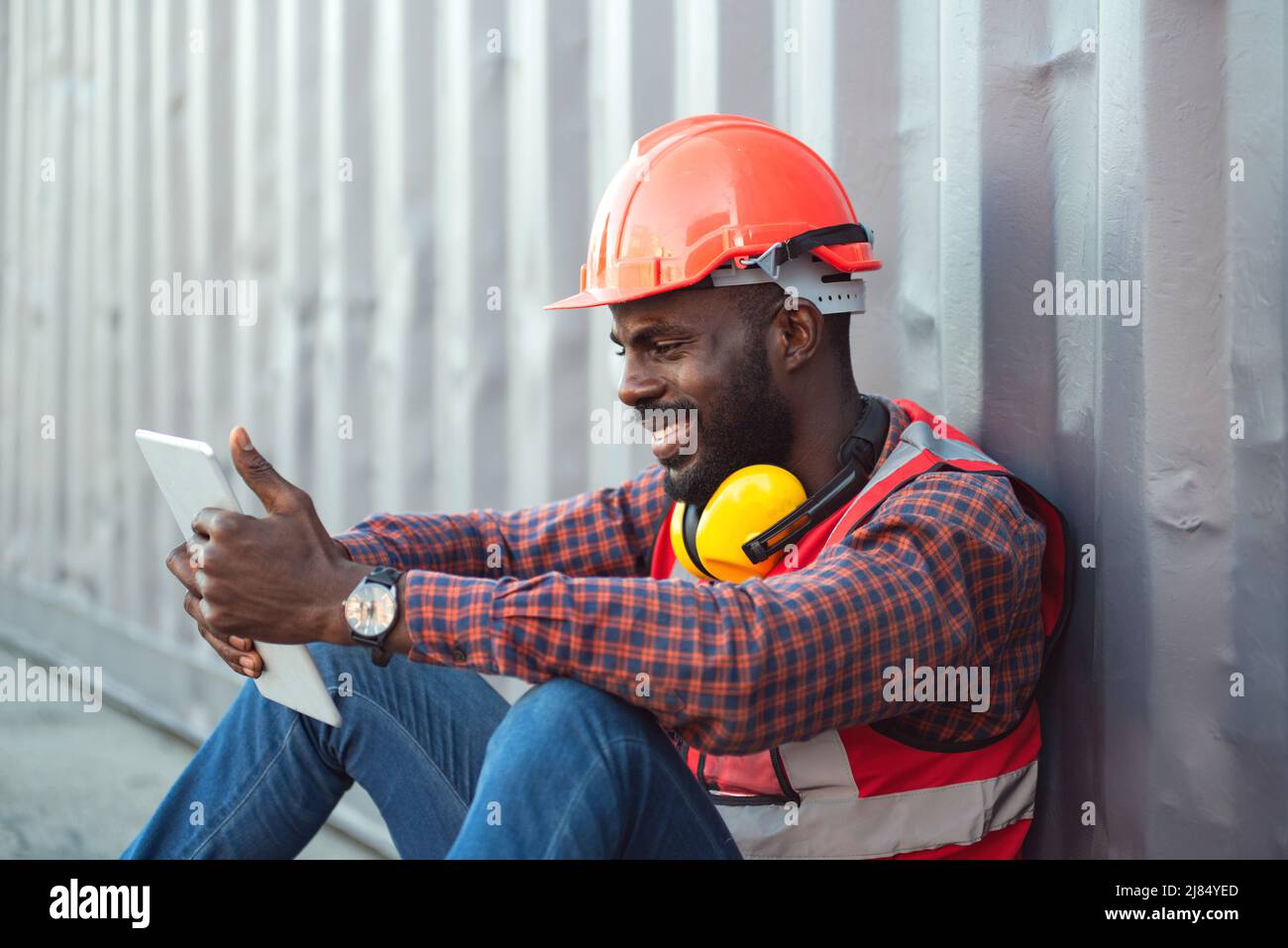 Close up happy smiling male African American engineer wearing safety ...