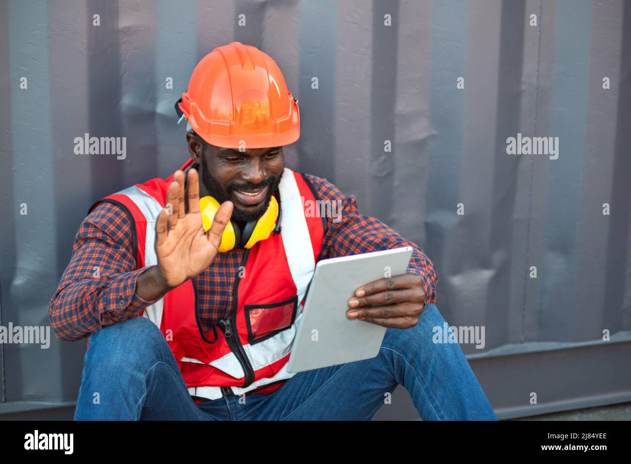 Close up happy smiling male African American engineer wearing safety ...