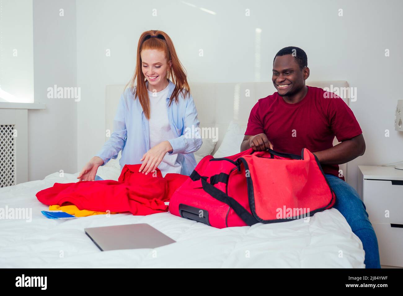 portrait of young couple with passports luggage and tickets packaging ...