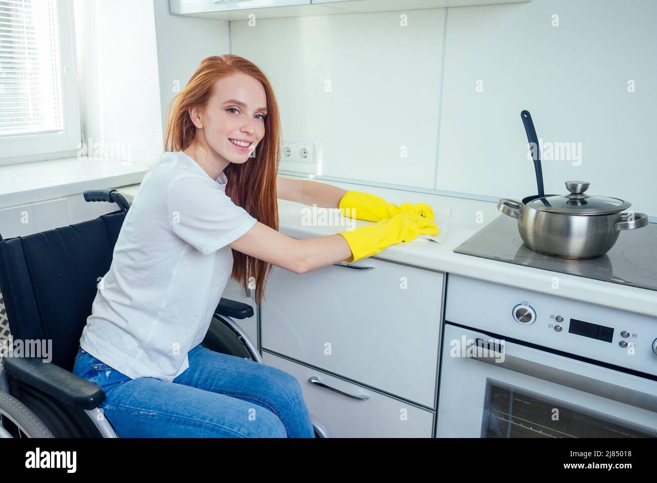 young redhaired ginger disabled woman in wheelchair wearing yellow ...
