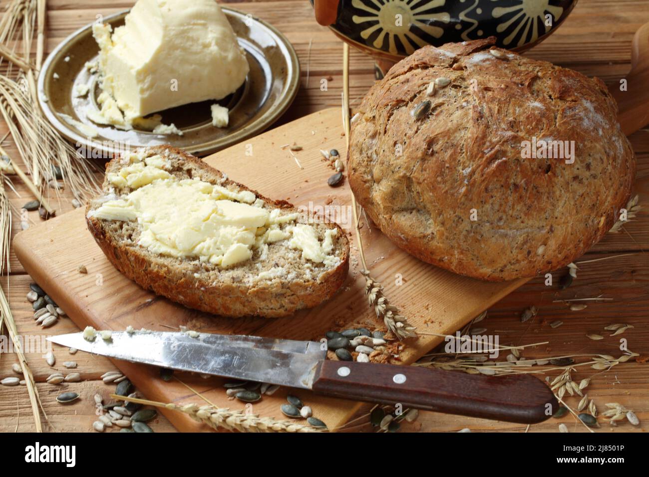 Hands spreading butter on bread Stock Photo - Alamy