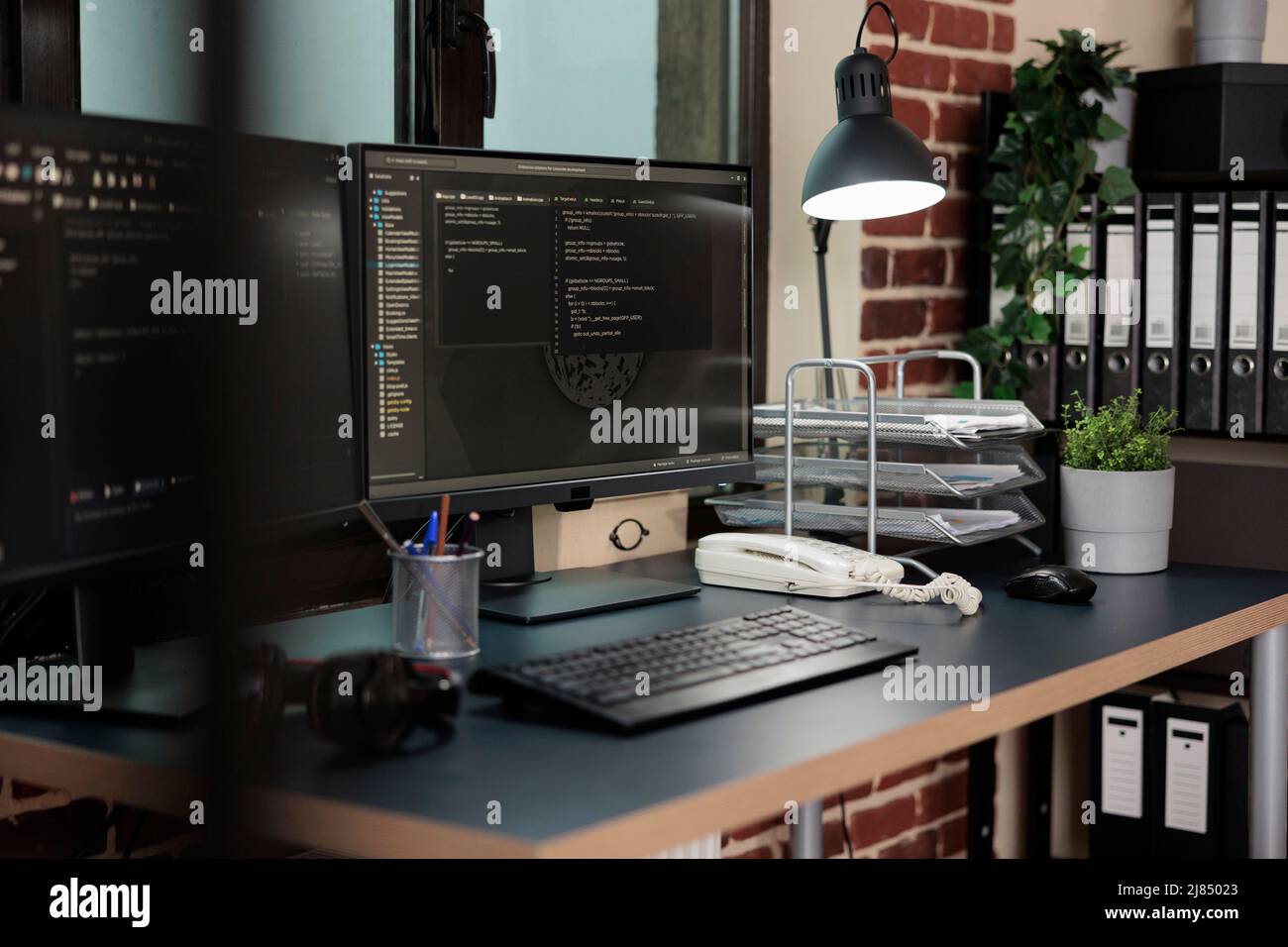 Empty office with nobody in it containing multiple displays showing ...