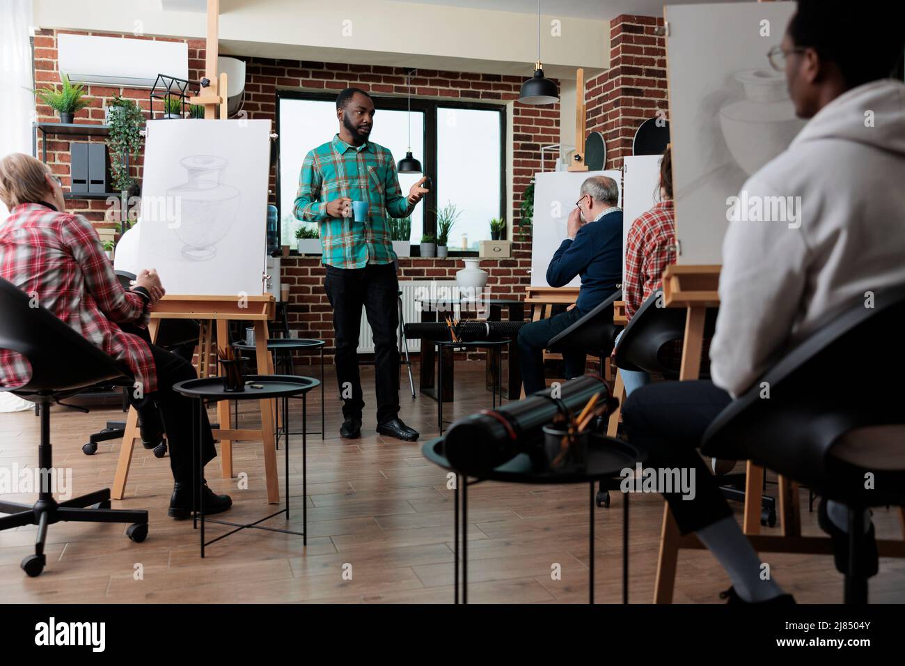 Multiethnic students attending art lesson learning drawing process for ...