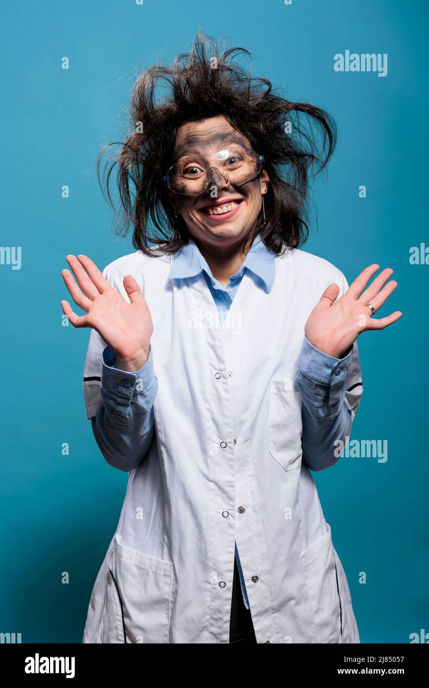 Happy smiling crazy scientist with messy hairstyle and dirty face ...
