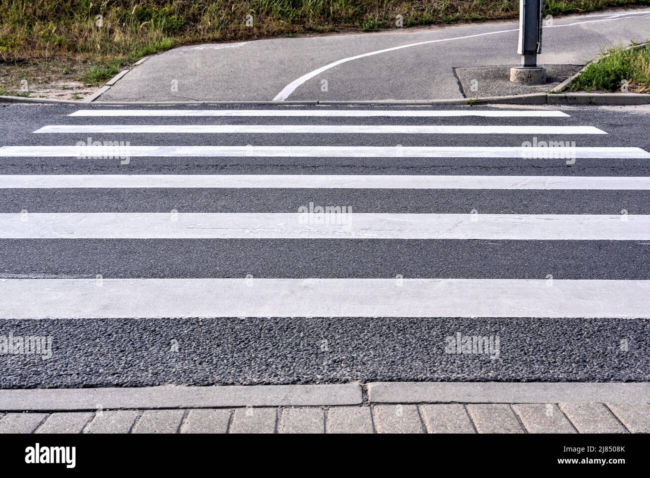 Empty pedestrian crossing on an asphalt road to cross the road ...