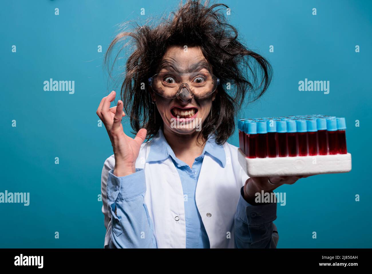 Insane chemistry specialist having laboratory glassware with test tubes ...