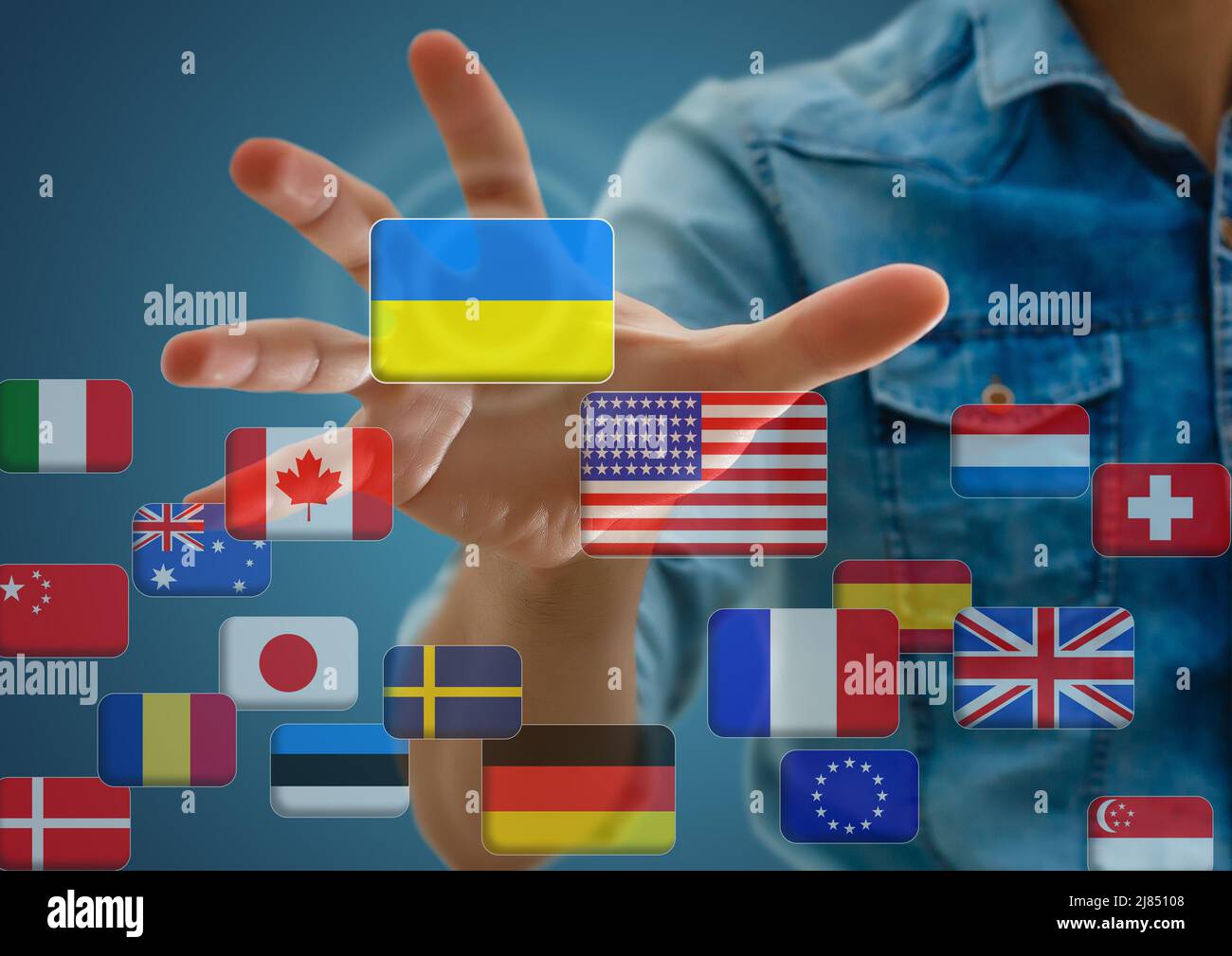 Hand pushing on a touch screen interface, choosing Ukraine. flags of ...