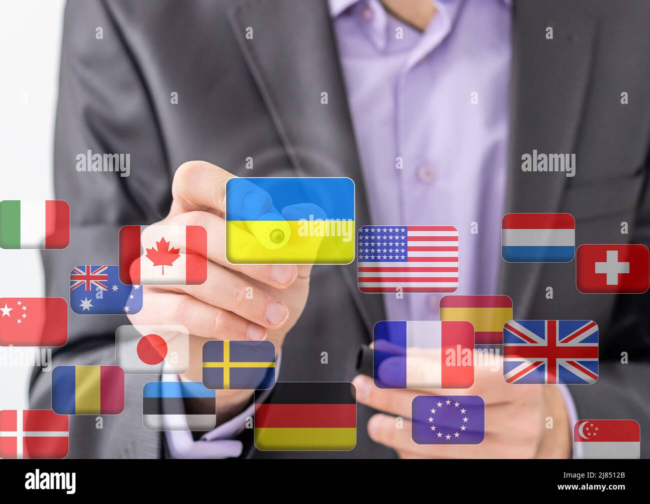 Hand pushing on a touch screen interface, choosing Ukraine. flags of ...