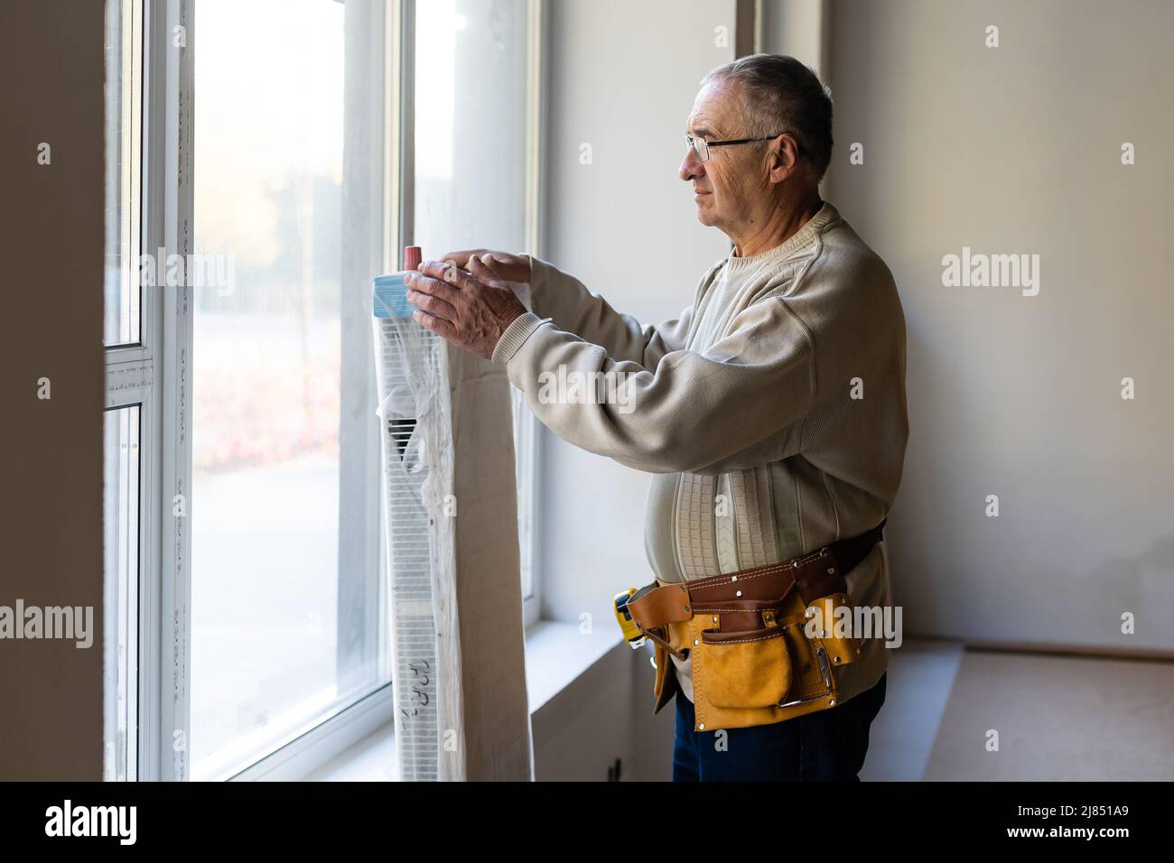 Installation of window in the office. window customizer Stock Photo - Alamy